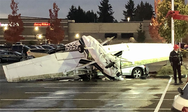 Pilot survives plane crash into car at South Hill parking lot ...